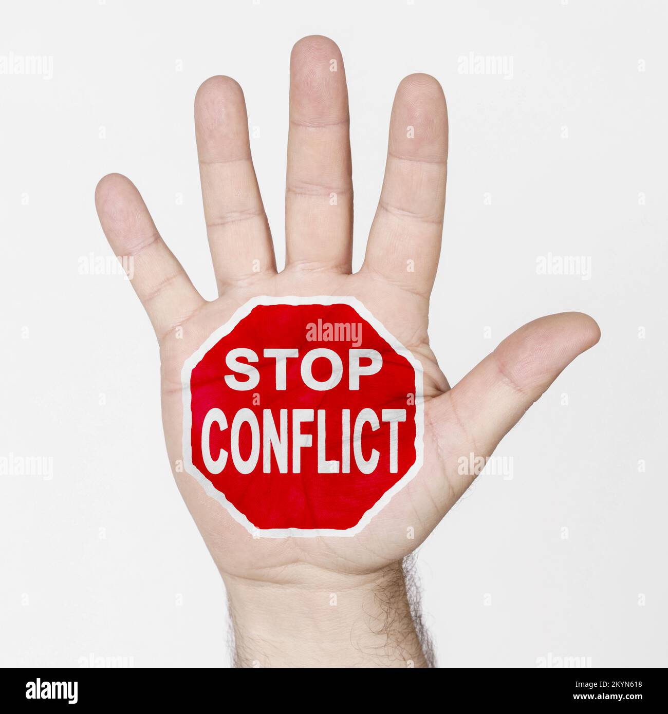 On the palm of the hand there is a stop sign with the inscription ...