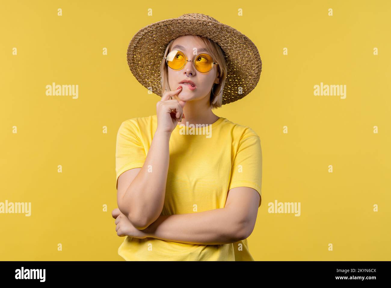 Thinking around woman on yellow background. Smart student girl finding ...