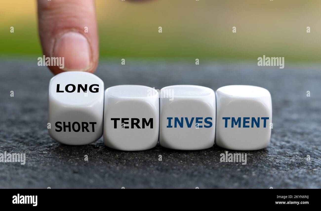 Hand turns dice and changes the expression 'short term investment' to ...