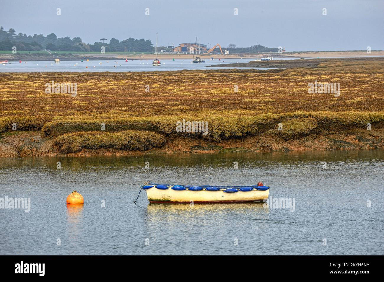 Boats reflected in the calm waters of the harbour at Wells-next-the-Sea ...