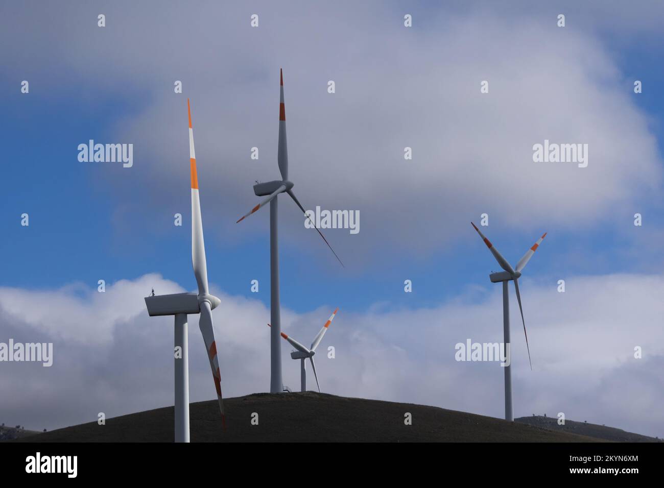 a wind farm full of turbines in the Italian mountains. The green ...