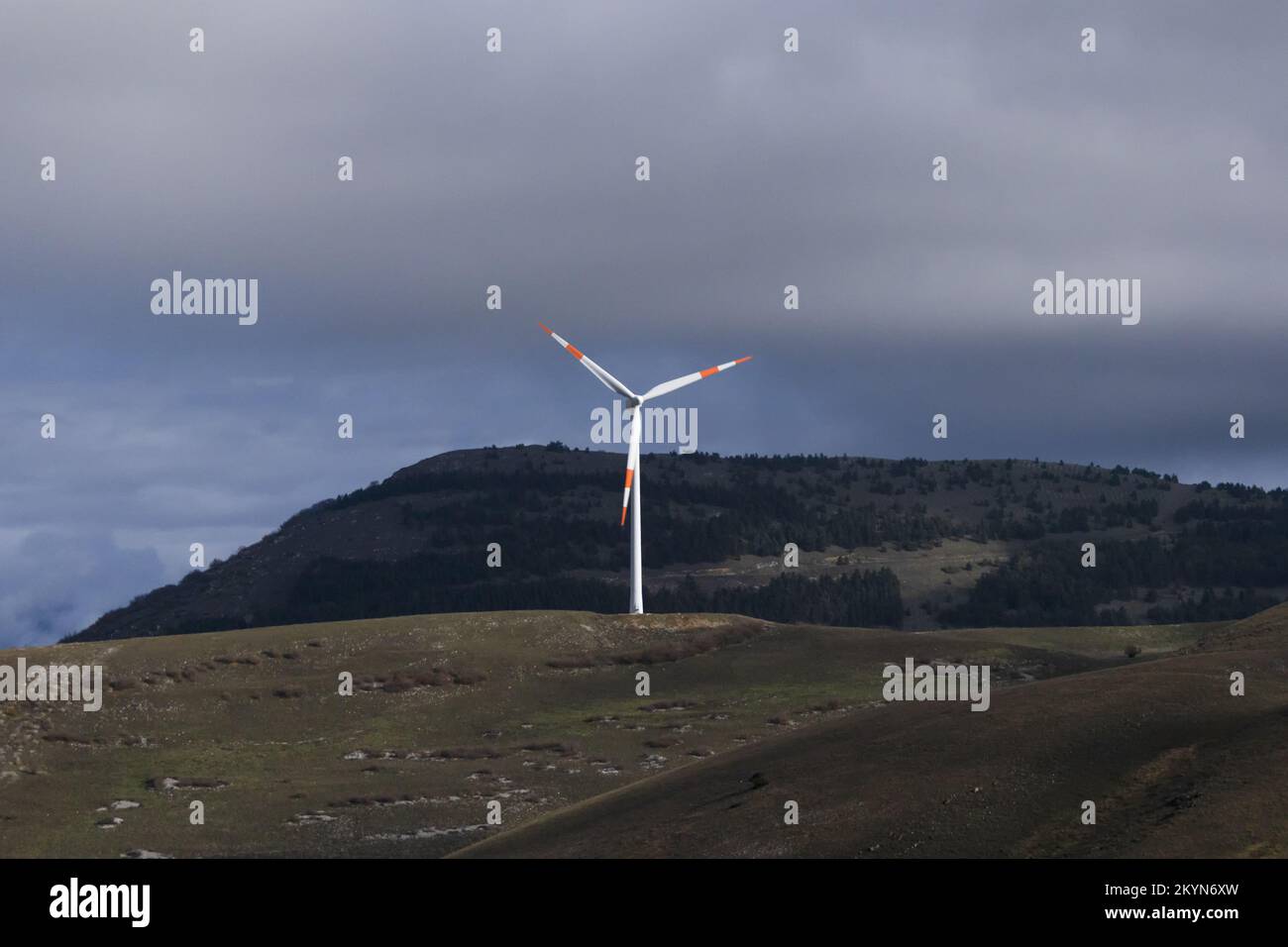 a wind farm full of turbines in the Italian mountains. The green ...