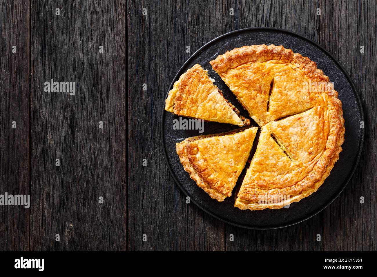 sliced Ground Beef Meat Pie with a flaky puff pastry double crust with ...