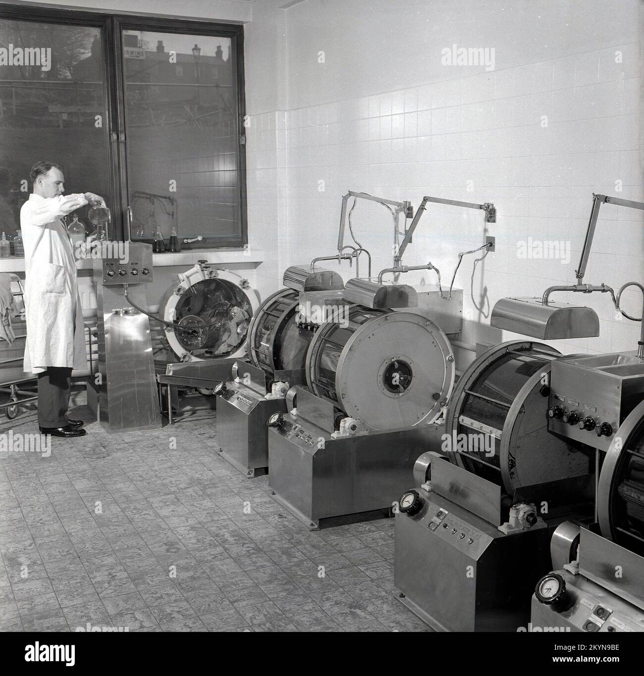 1950s, historical, inside a room at a factory, a male research ...
