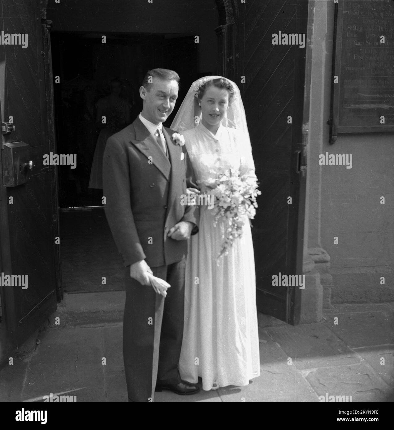 1953, historical, a newly married couple standing together outside the ...