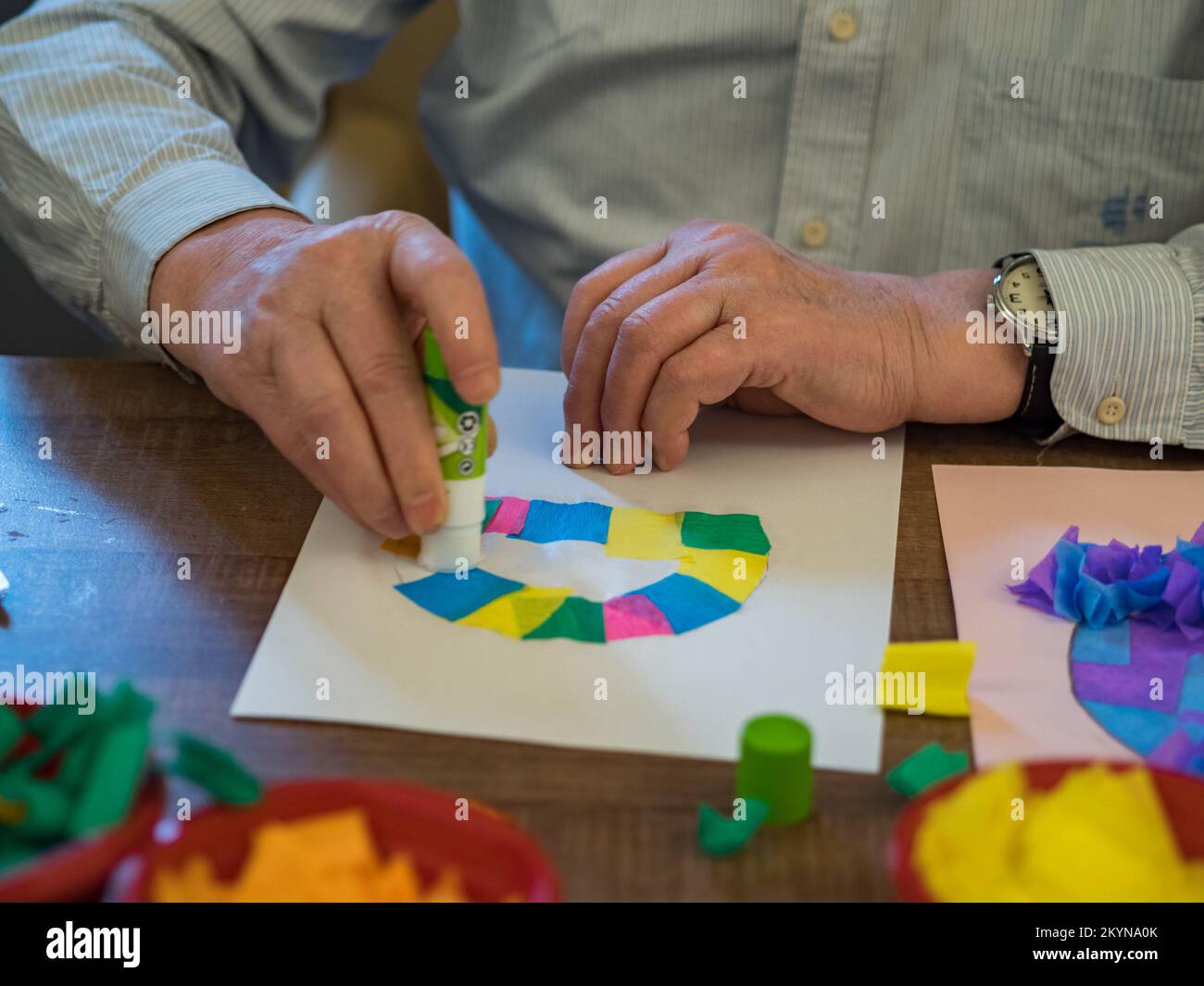 Senior activity concept. Exercises by cutting, gluing and creating ...