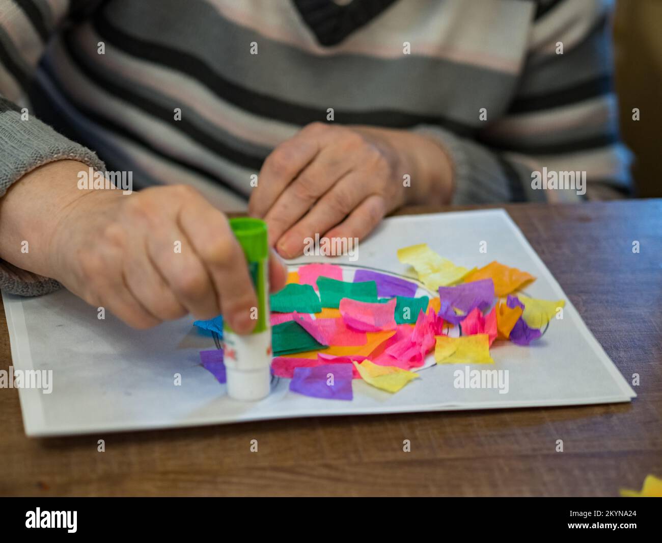 Senior activity concept. Exercises by cutting, gluing and creating ...