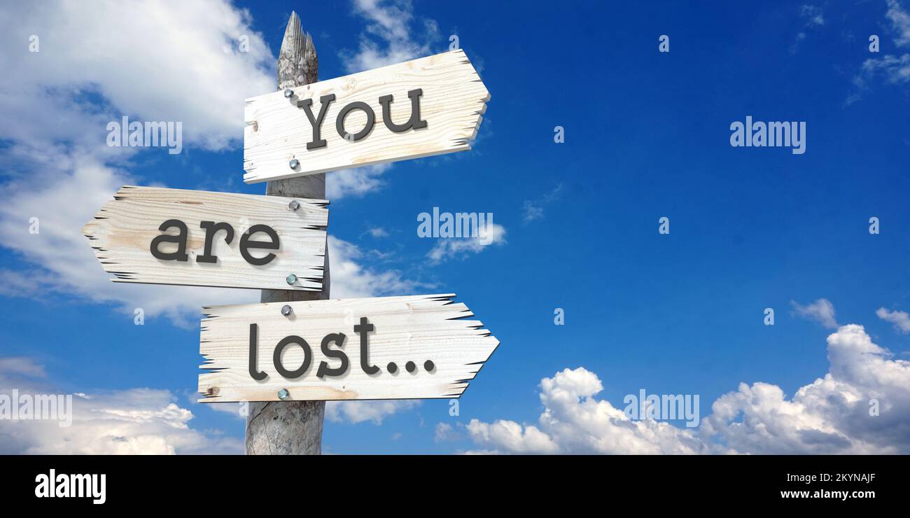 You are lost - wooden signpost with three arrows Stock Photo - Alamy