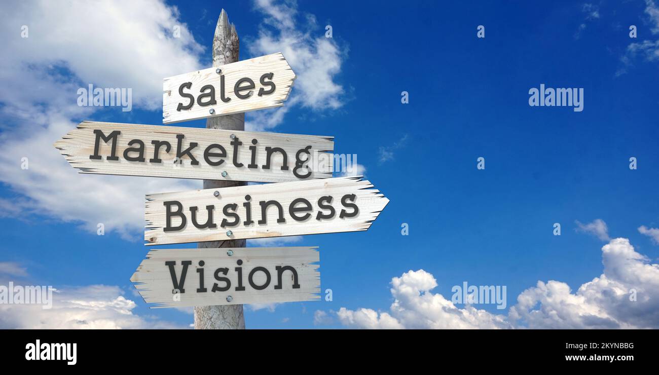 Sales, marketing, business, vision - wooden signpost with four arrows ...