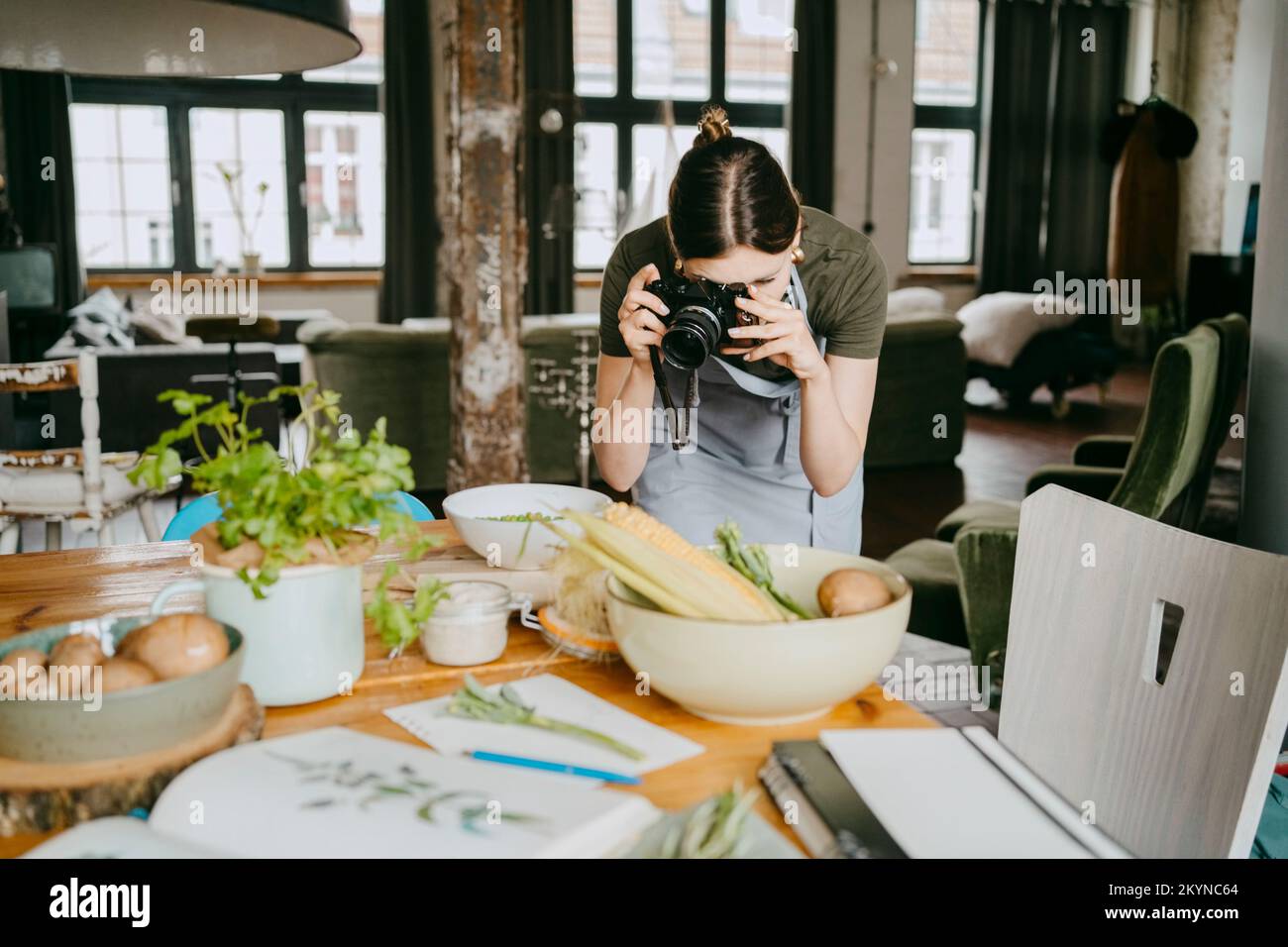 Food stylist photographing using digital camera in studio Stock Photo ...