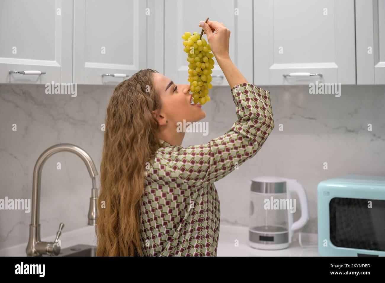 Woman eating grapes hi-res stock photography and images - Alamy