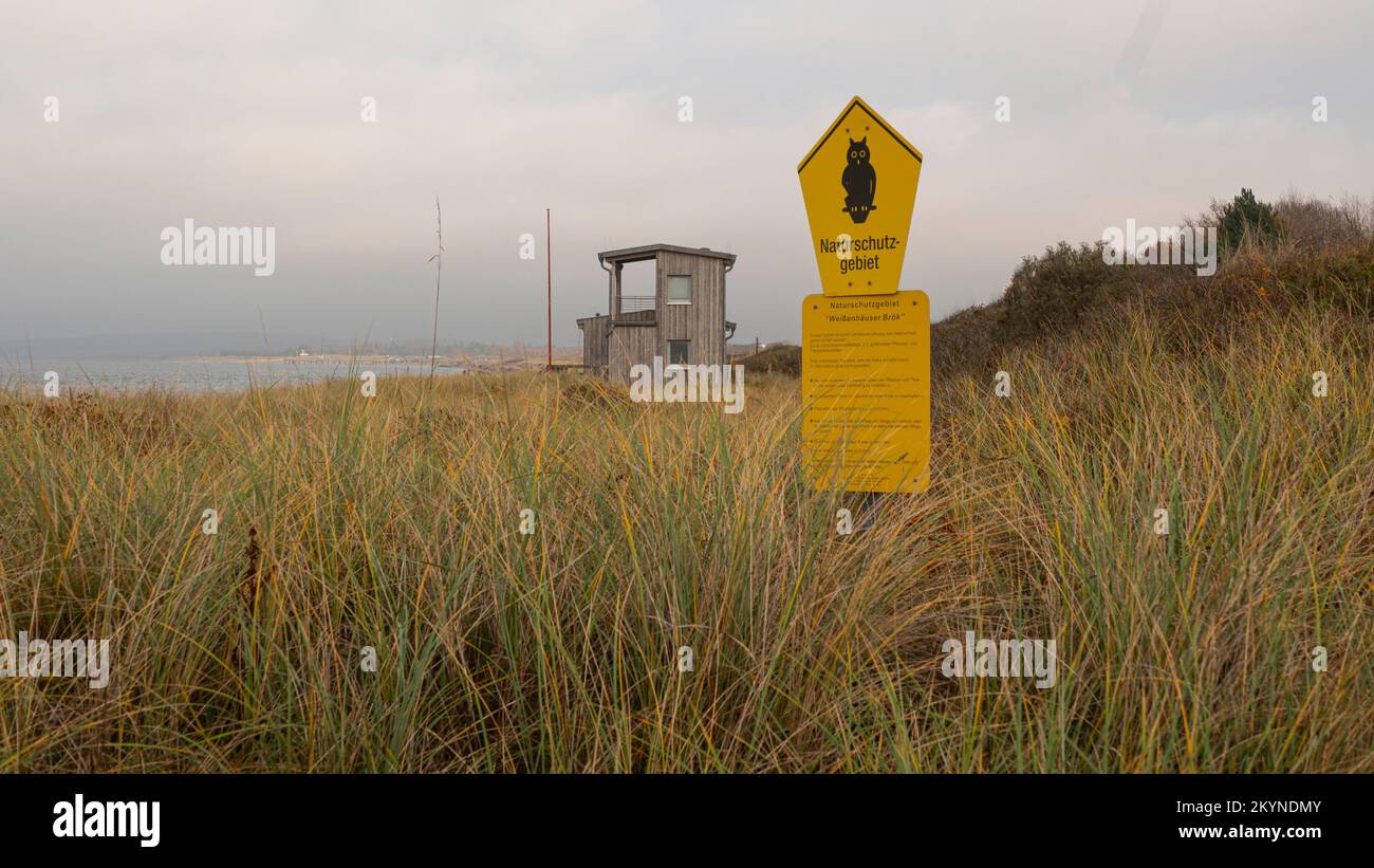 Sign post by the sea saying Naturschutzgebiet - meaning Nature Reserve ...