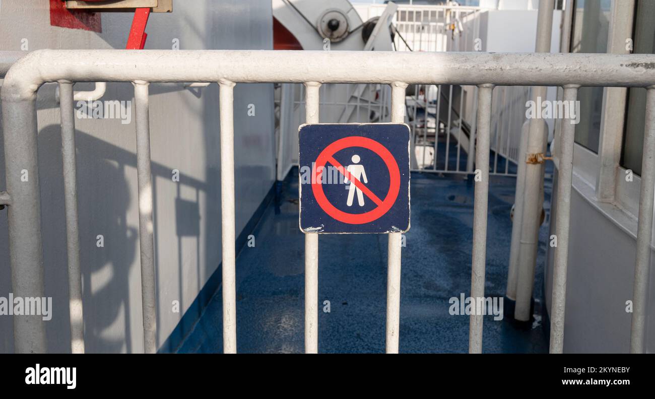 Warning sign icon on metal railings on ships sying no unauthorised ...