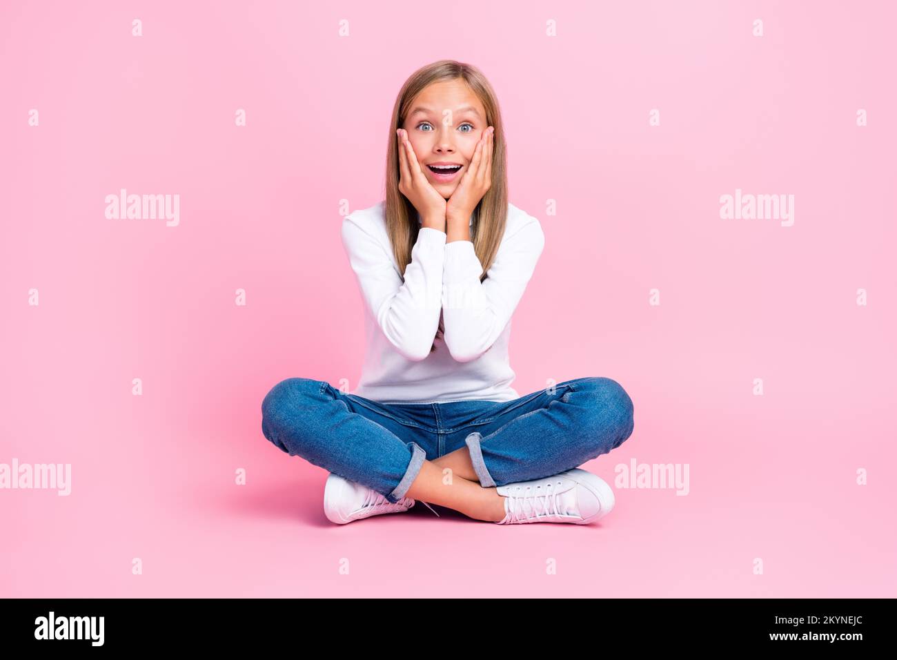 Full body portrait of astonished girl sit floor hands cheeks unexpected ...