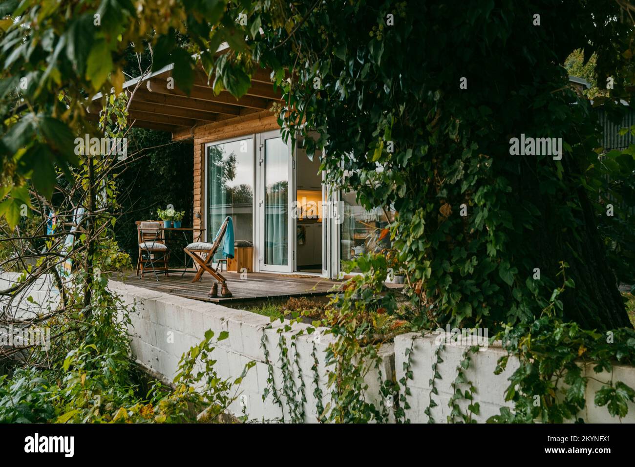 Empty porch with chairs by doorway outside house Stock Photo - Alamy