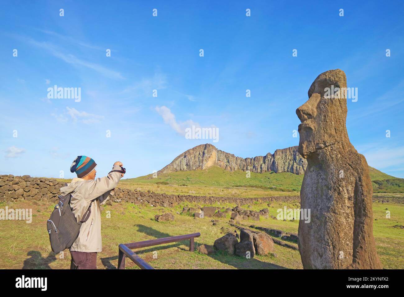 Visitor taking photos of Moai A Vere Ki Haho or "Traveling Moai", a ...