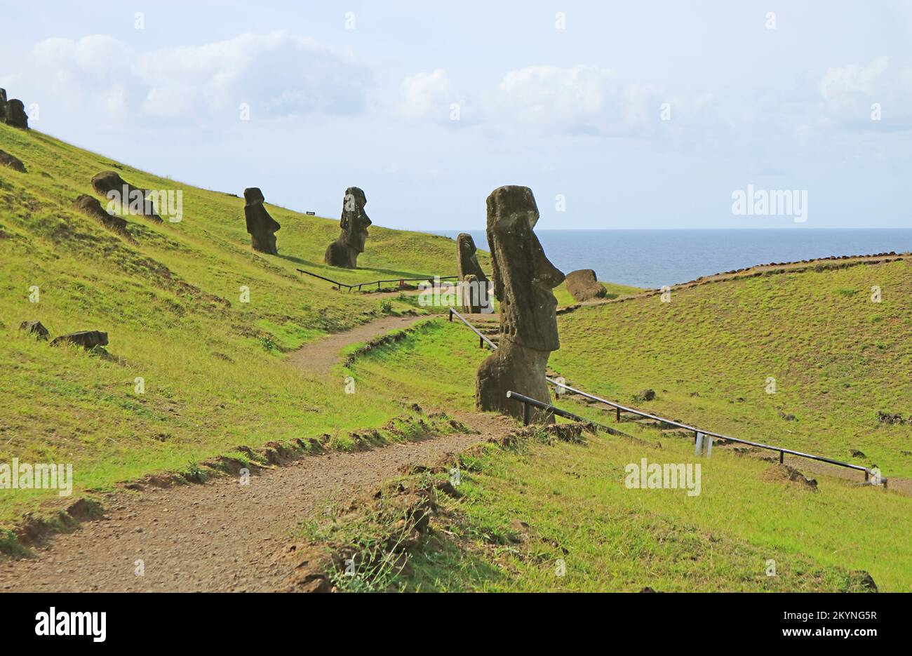 Group of abandoned massive Moai statues scattered on the slope of Rano ...