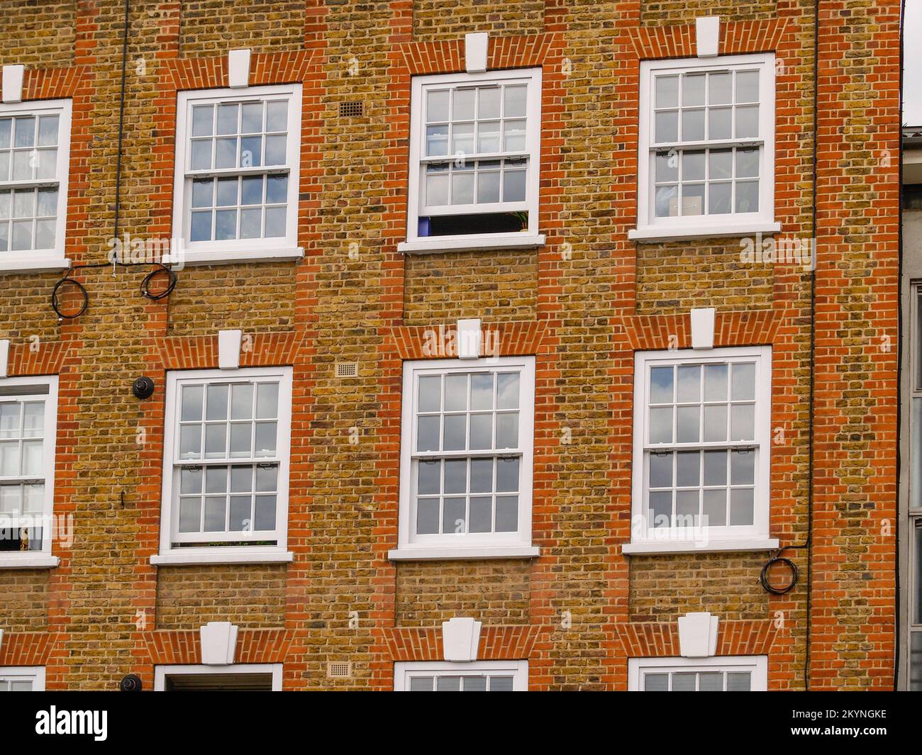 Mid-century brick multi-story apartment block with rows white double ...