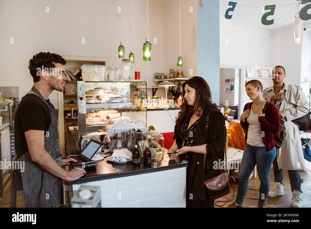 Cafe owner talking to customer hi-res stock photography and images - Alamy