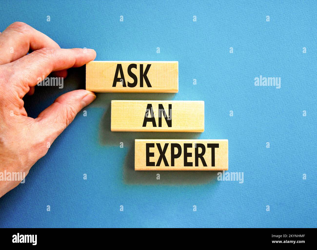 Ask an expert symbol. Concept words Ask an expert on wooden blocks on a ...