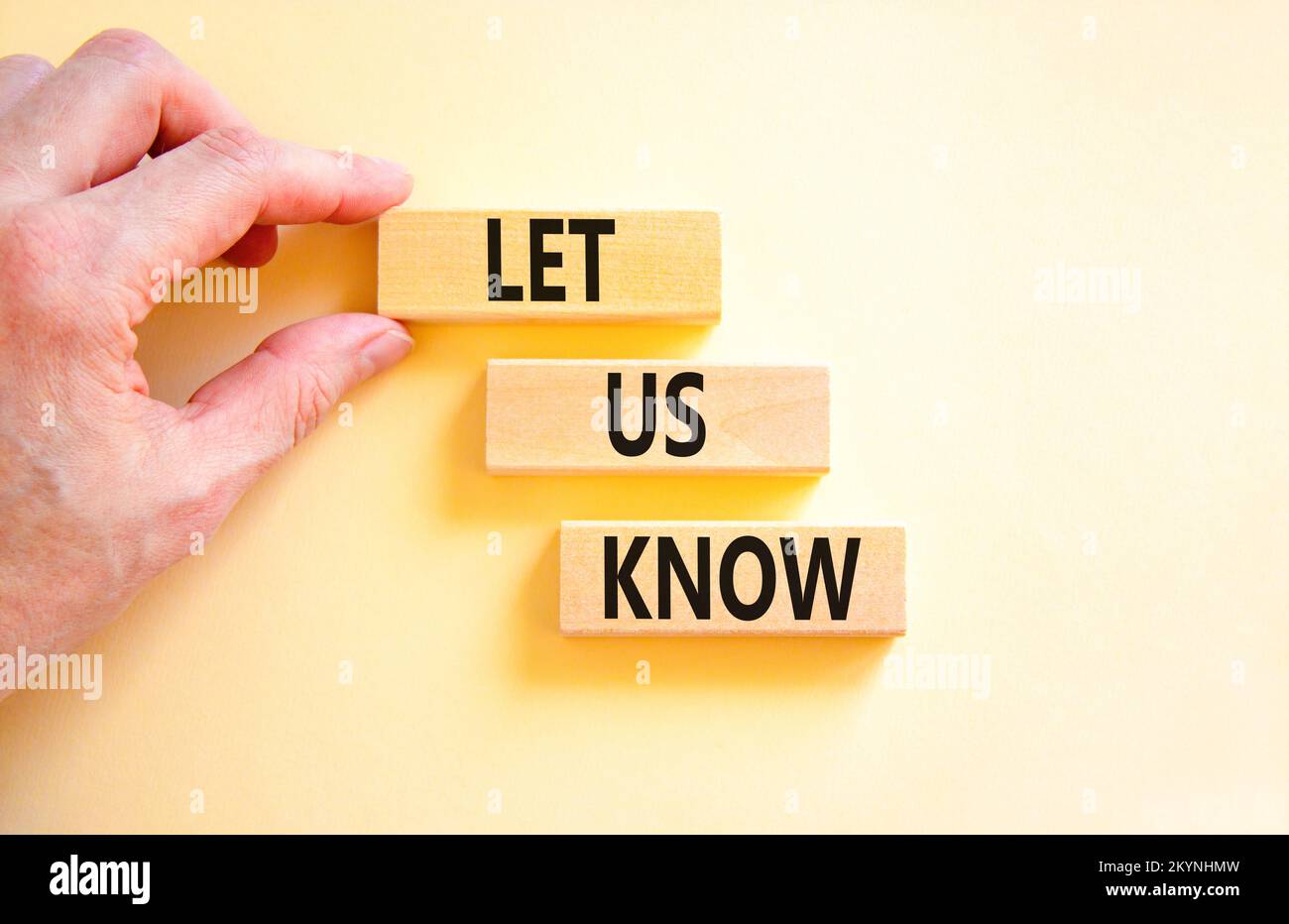 Let us know symbol. Concept words Let us know on wooden blocks on a ...