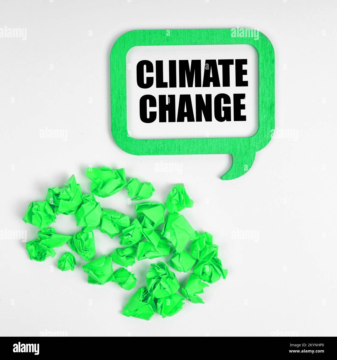 Ecology concept. On a white background, green crumpled pieces of paper ...