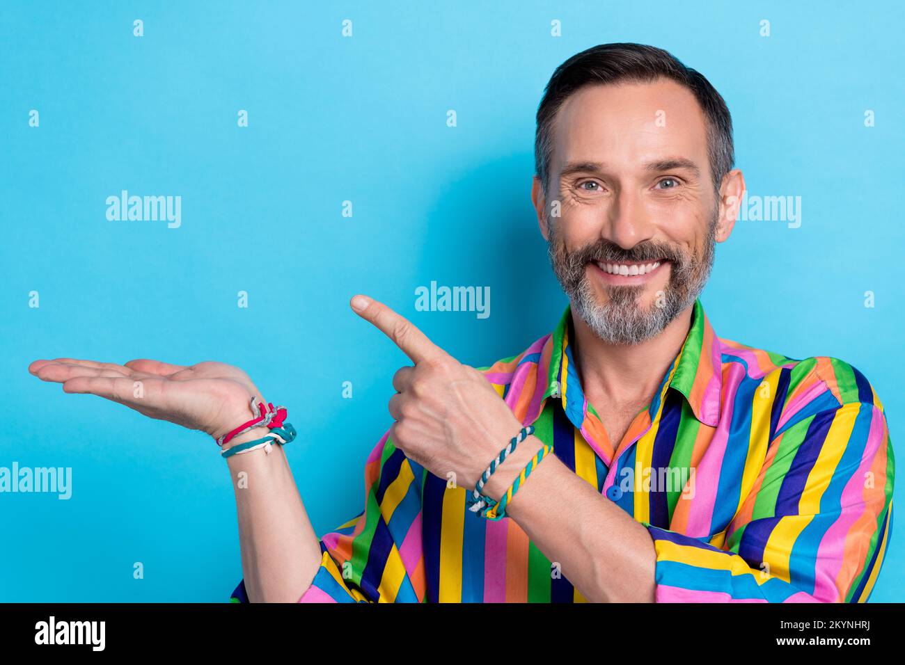 Portrait of handsome smiling mature man wear striped colorful shirt ...