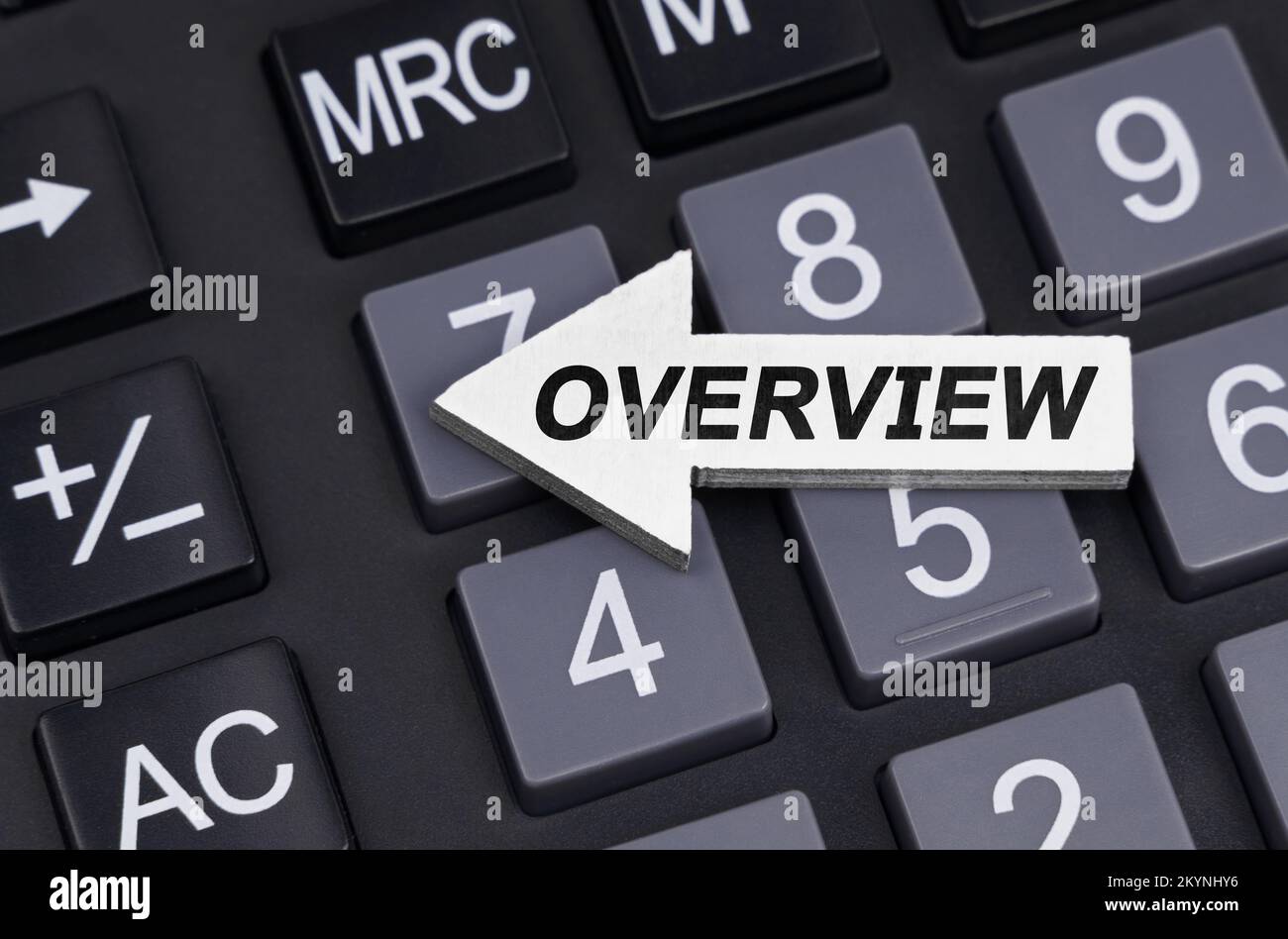 Business and finance concept. There is a white arrow on the calculator ...