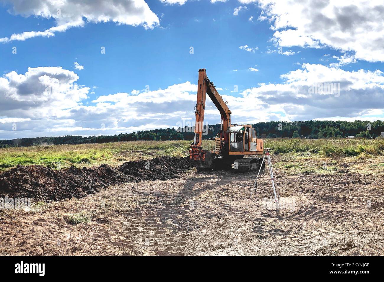 Excavator, construction site, level, against the background of a blue ...