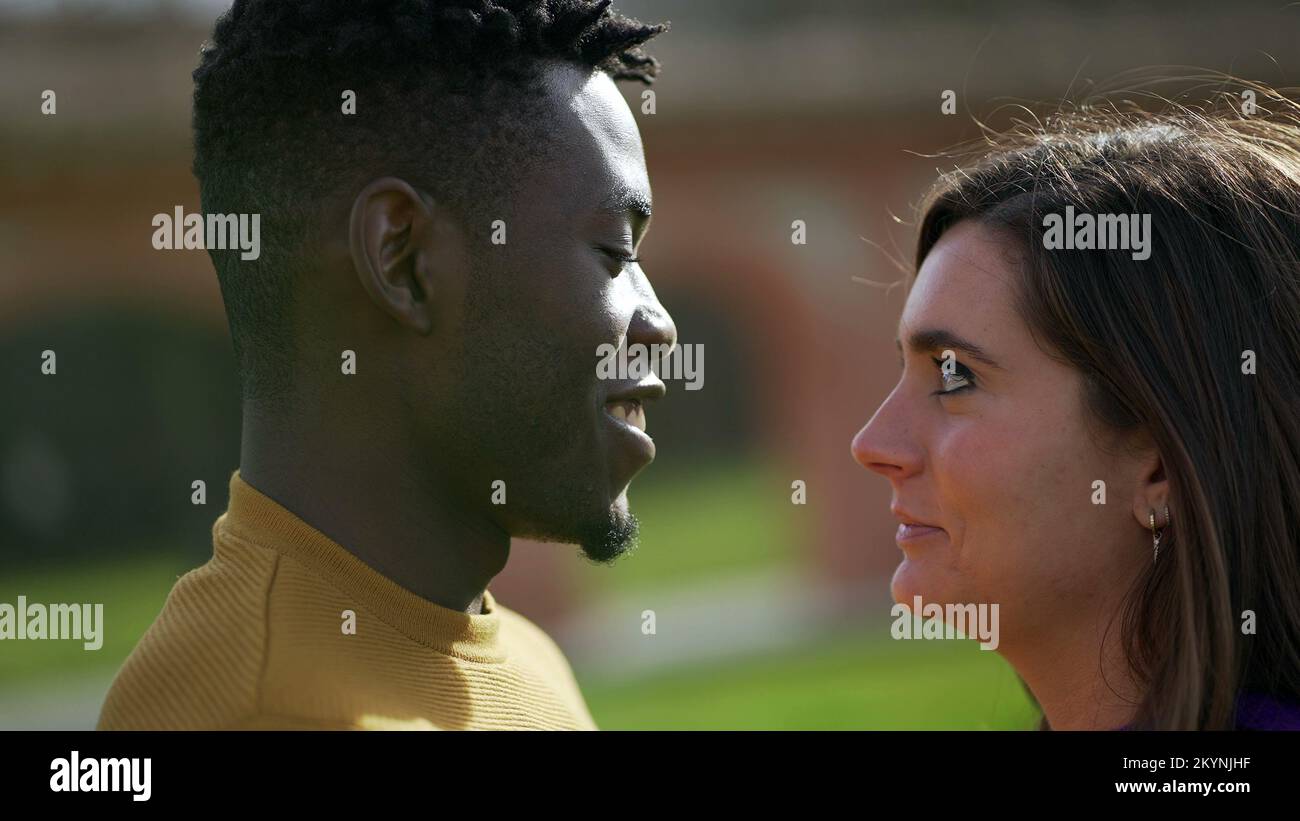 Young interracial couple dating at park, ethnically diverse ...
