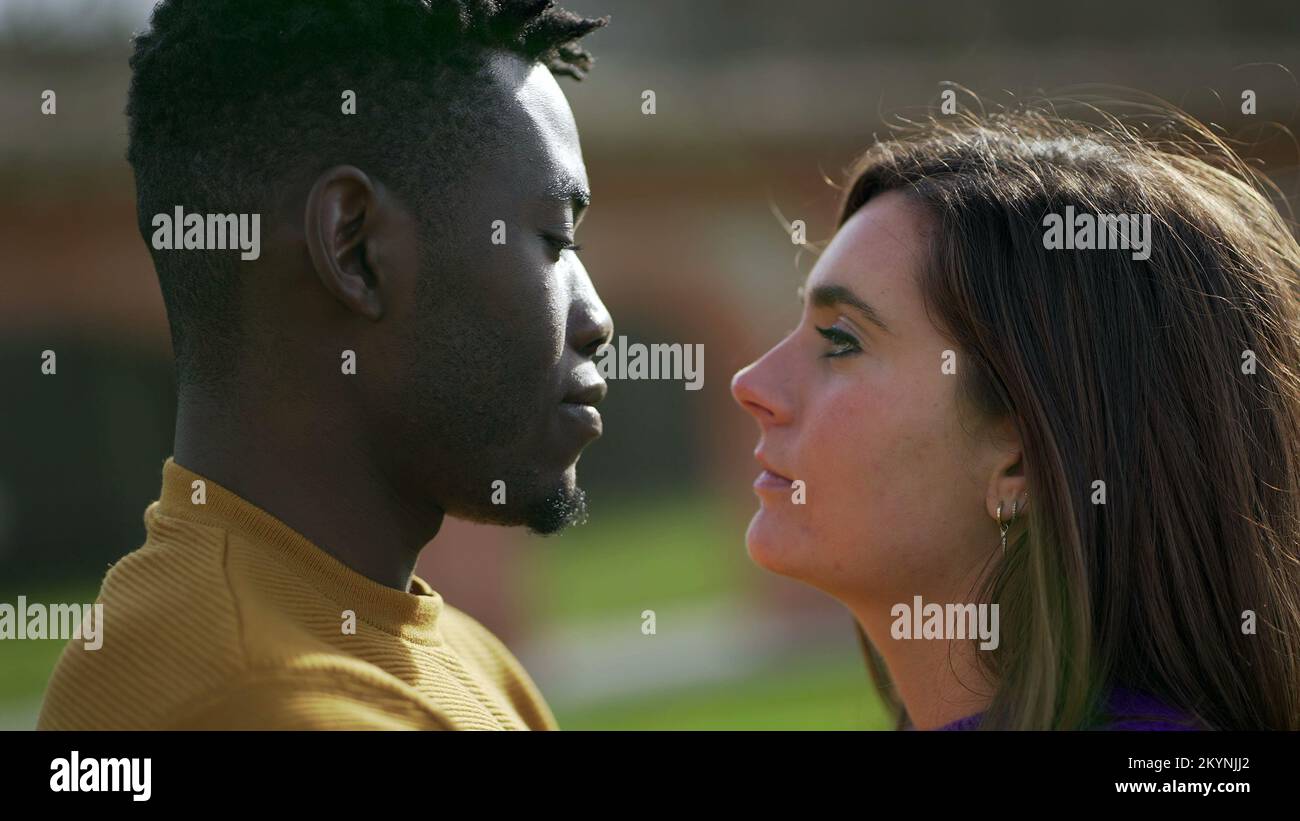 Young interracial couple dating at park, ethnically diverse ...