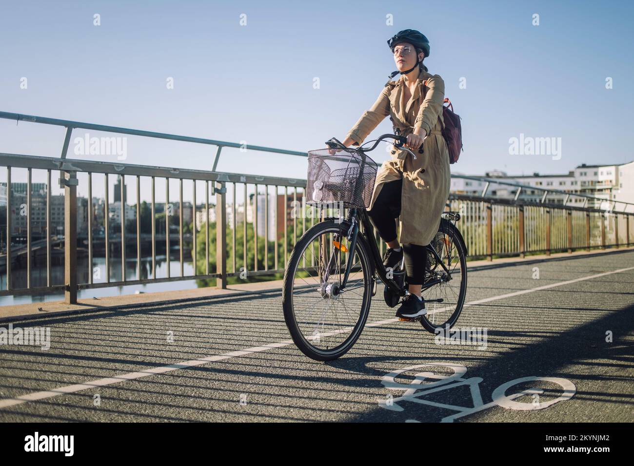 Young businesswoman riding cycle on bicycle lane while commuting to work Stock Photo - Alamy