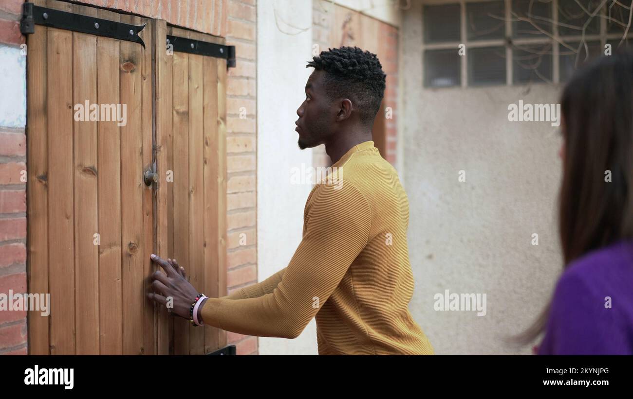 People leaving home closing door. Young interracial couple going out ...