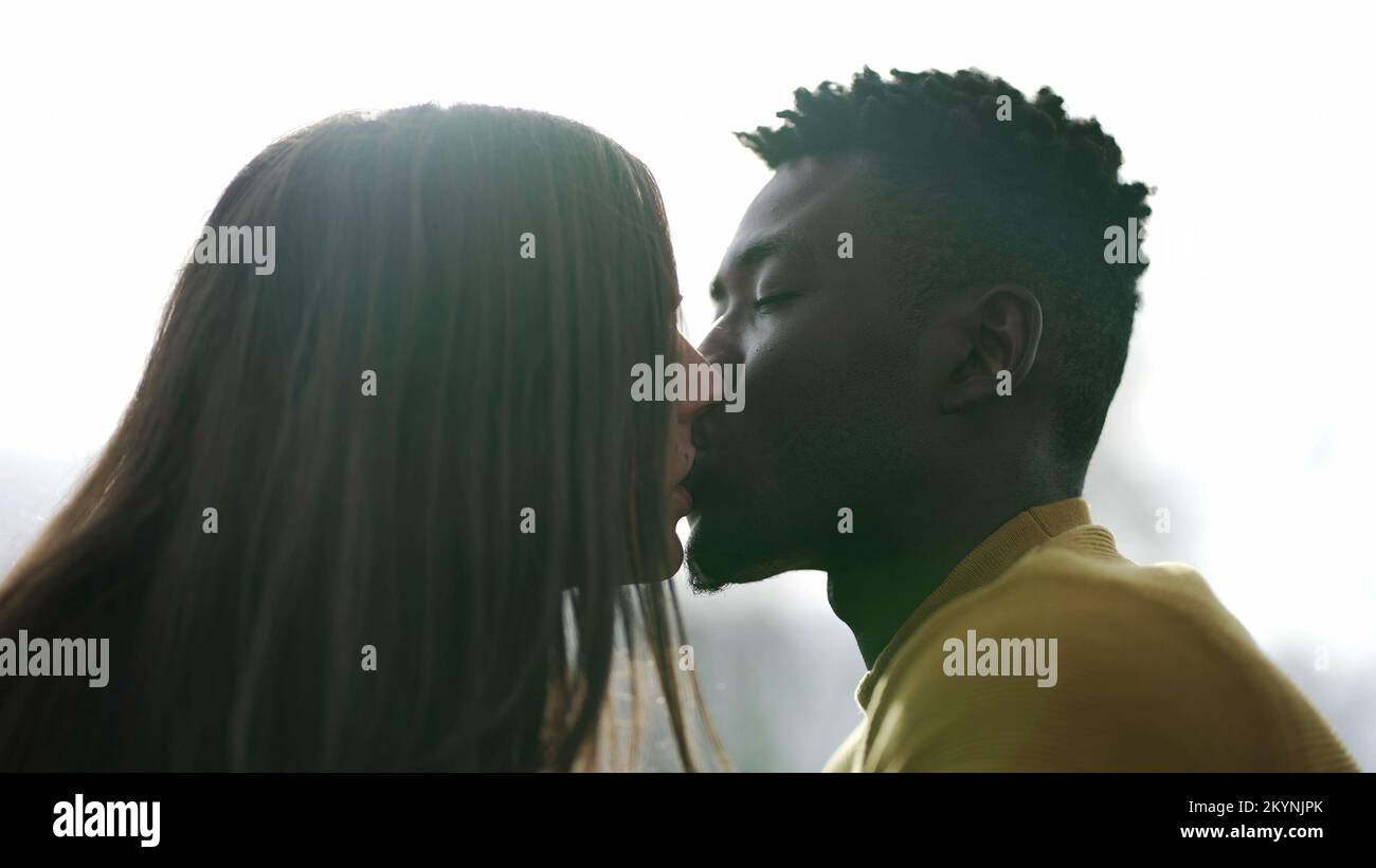 Young interracial couple kissing outside. Black man with white ...