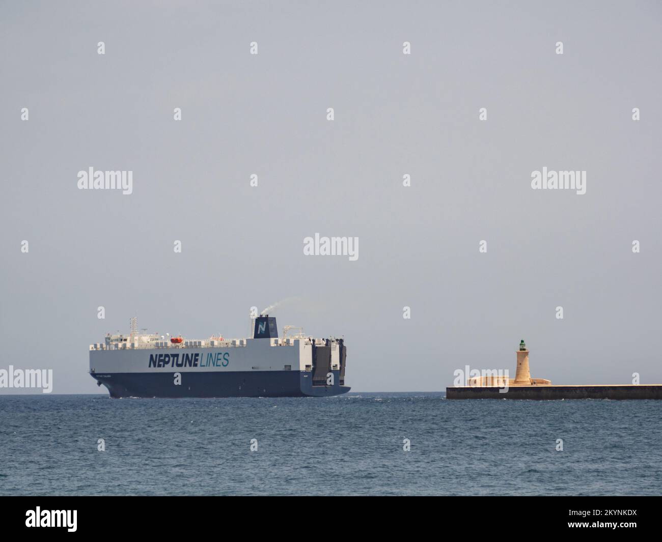 Valletta, Malta - May 2021. A huge cargo ship leaving the port. Neptune ...