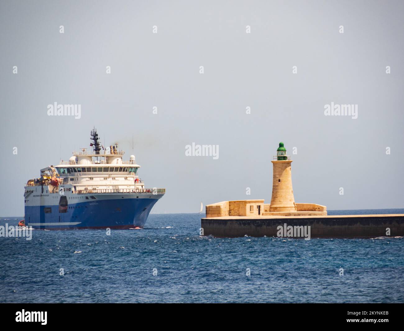 Valletta, Malta - May 2021. A huge cargo ship leaving the port. Neptune ...