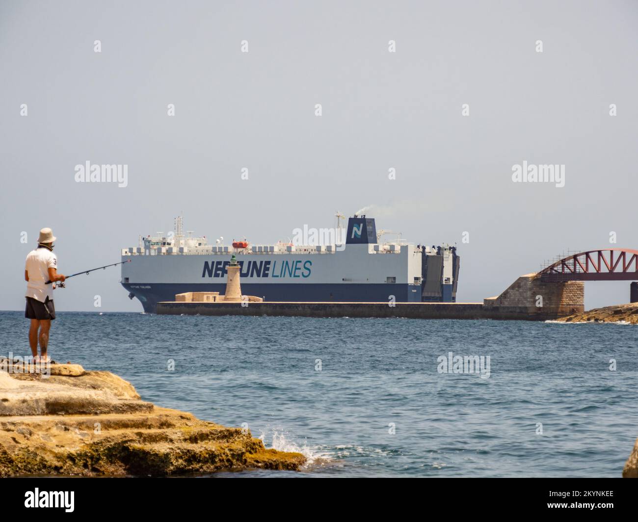 Valletta, Malta - May 2021. A huge cargo ship leaving the port. Neptune ...
