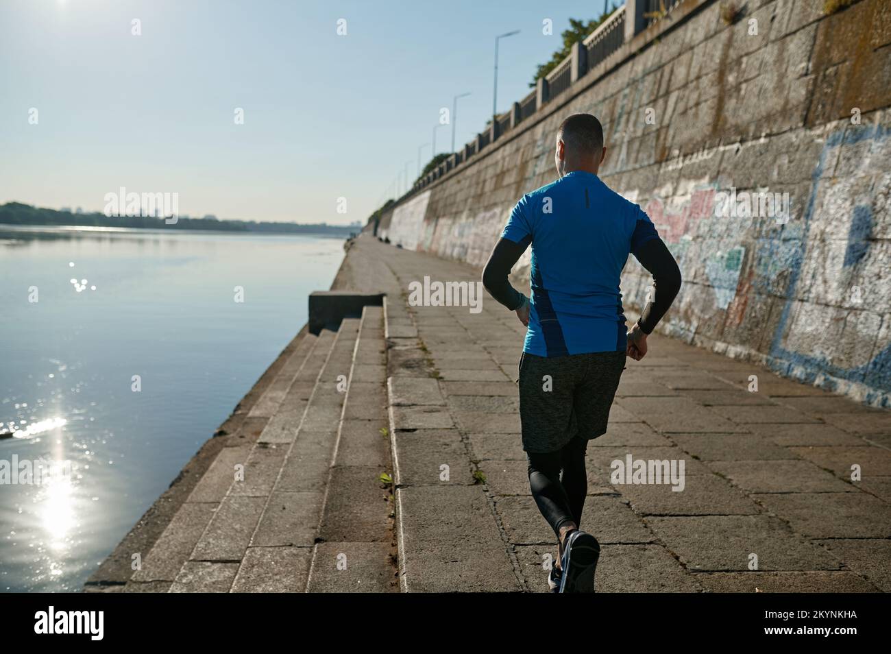 Athletic man running and doing functional workout outdoors Stock Photo ...