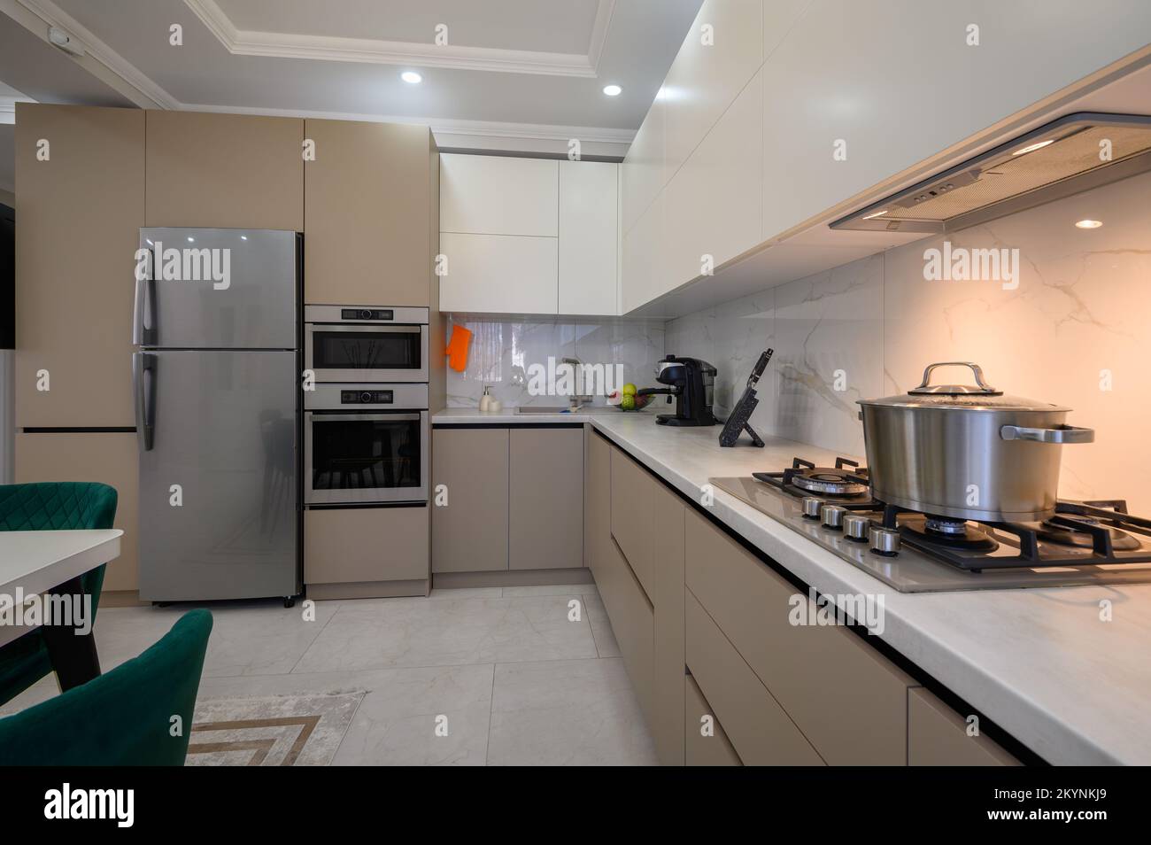 Modern white and beige large luxurious kitchen and dining table in ...