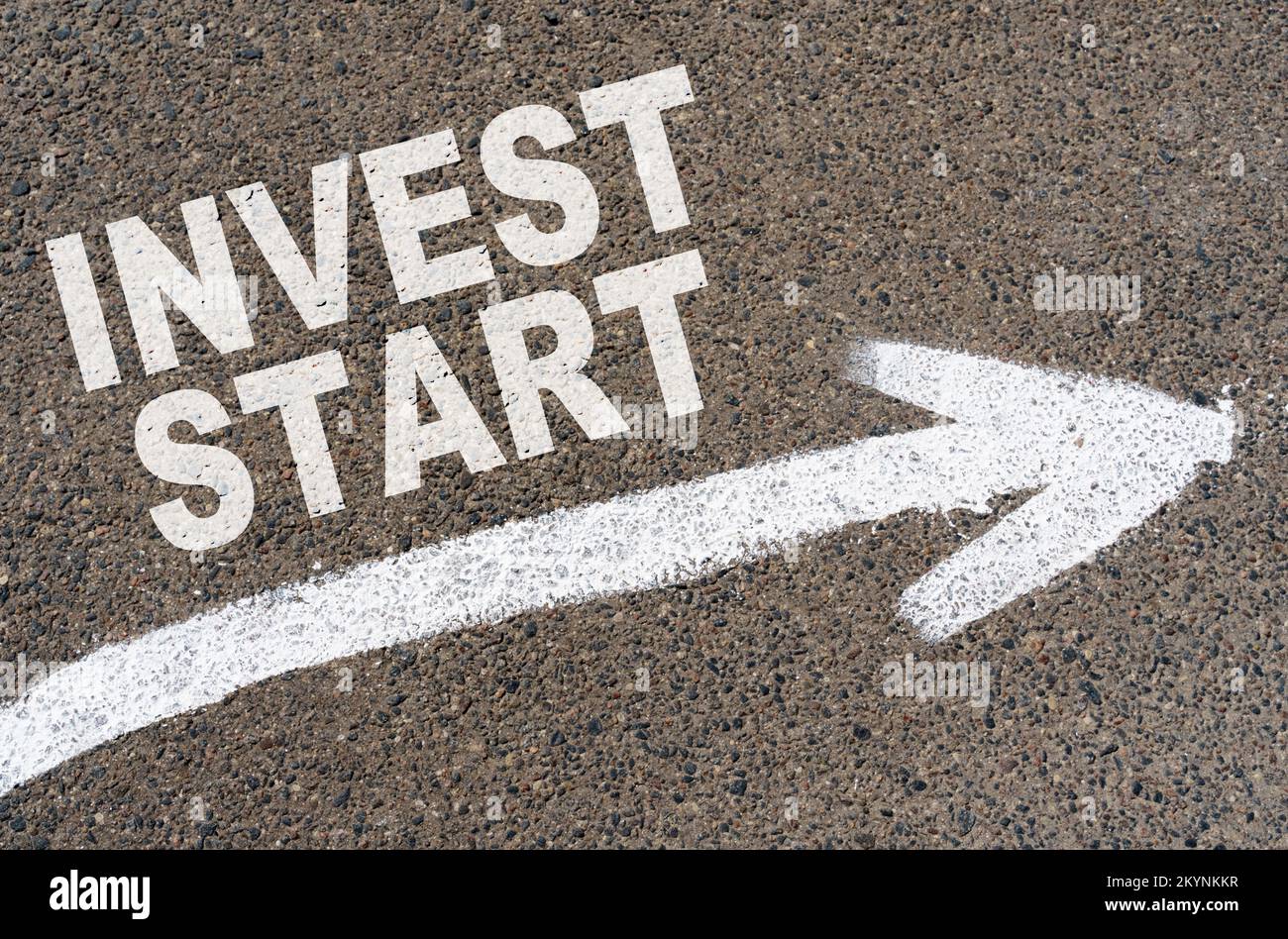 Business concept. On the asphalt road markings an arrow with the ...