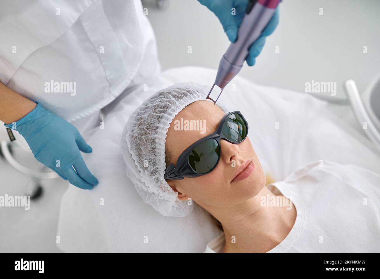 Woman preparing laser rejuvenation procedure hi-res stock photography ...