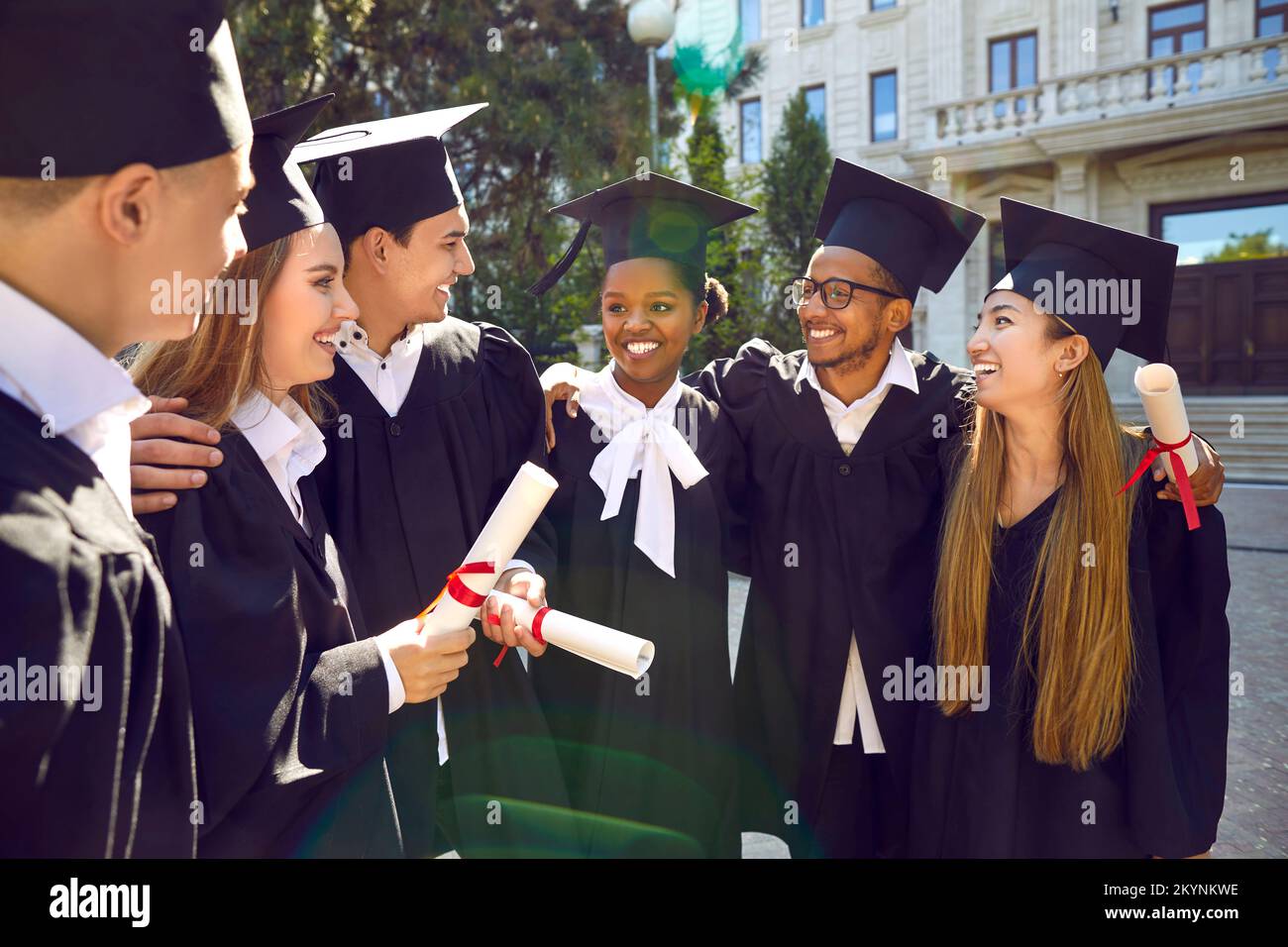 Live photo of happy talking group graduate people with diplomas after ...