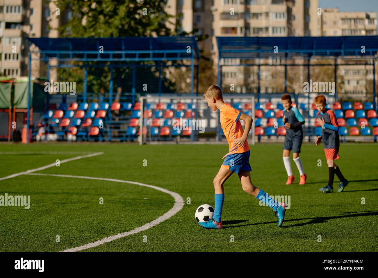 Young boys playing football soccer match at training camp for kids ...