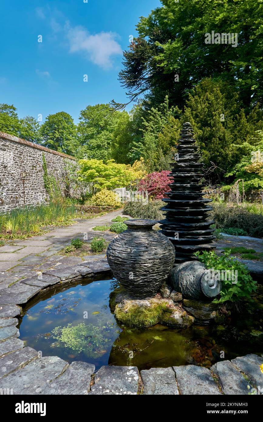 Slate and stone sculptures in a water feature at Threave Gardens near ...