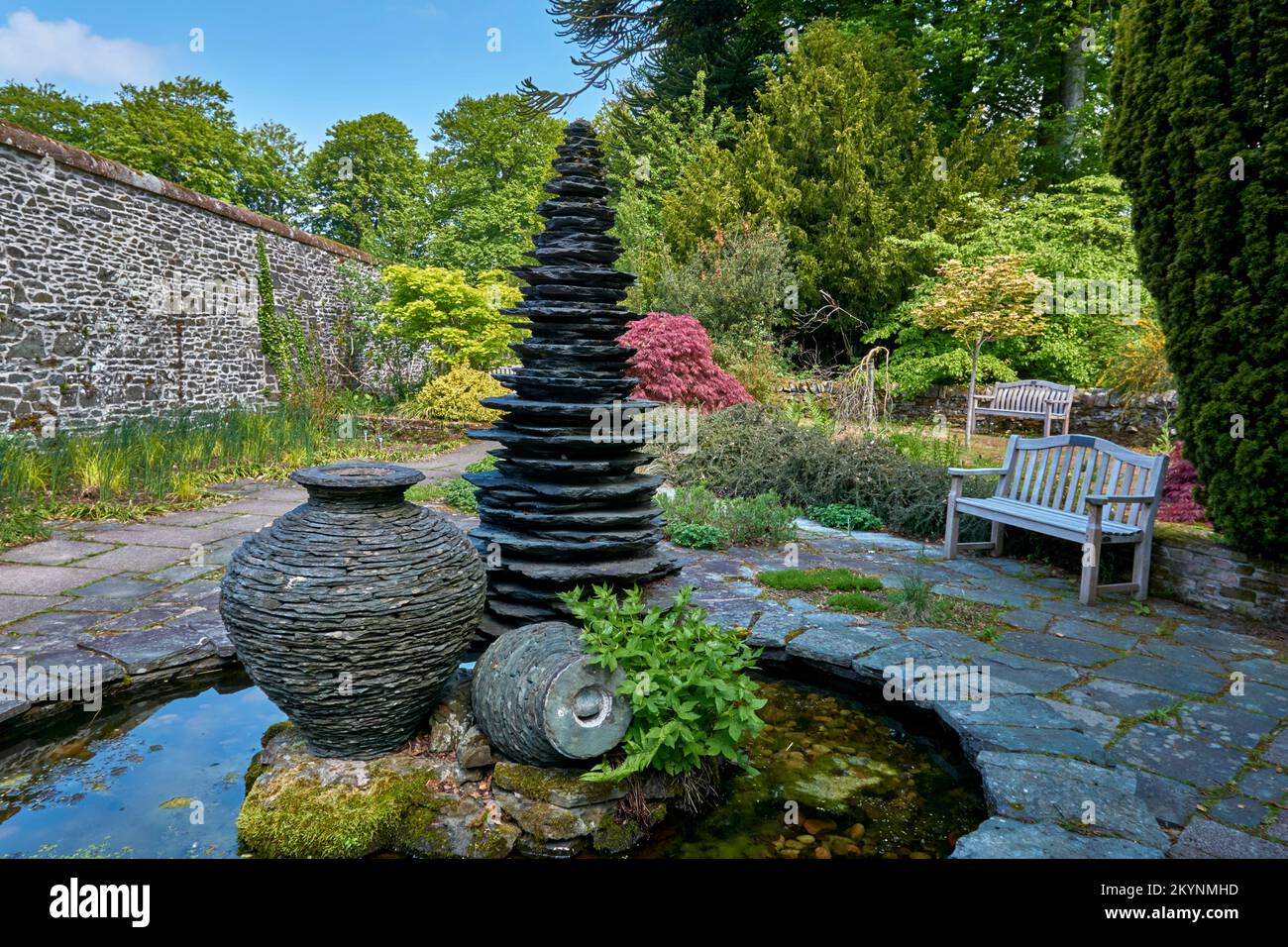 Slate and stone sculptures in a water feature at Threave Gardens near ...