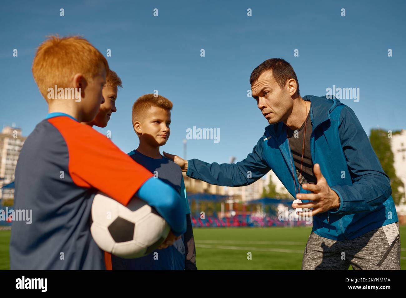 Confident soccer coach encouraging young football team Stock Photo - Alamy