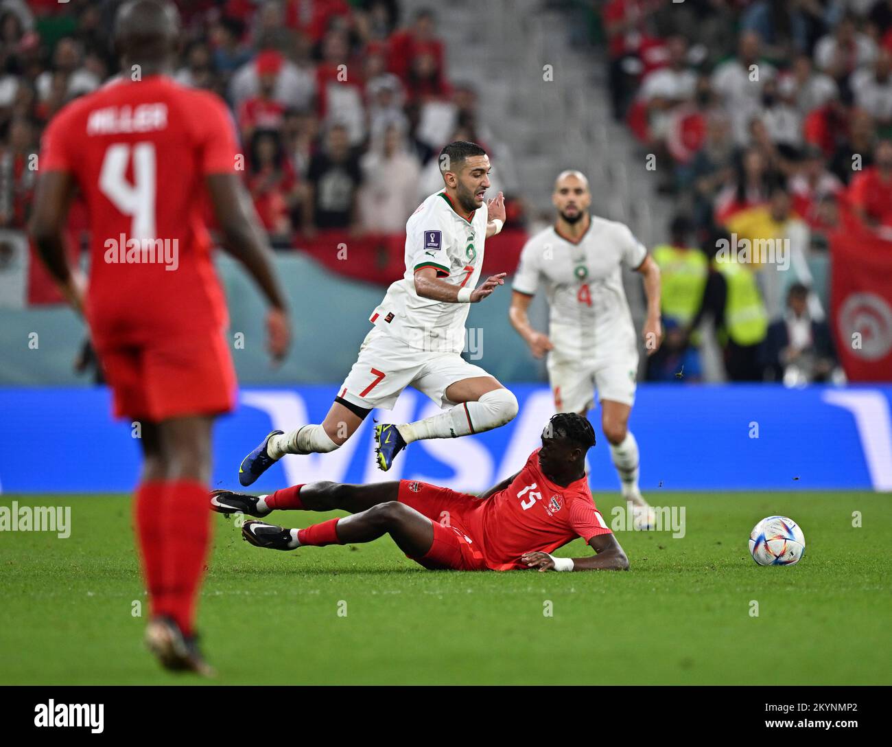 Doha, Qatar. 1st Dec, 2022. Ismael Kone (bottom) of Canada and Hakim ...
