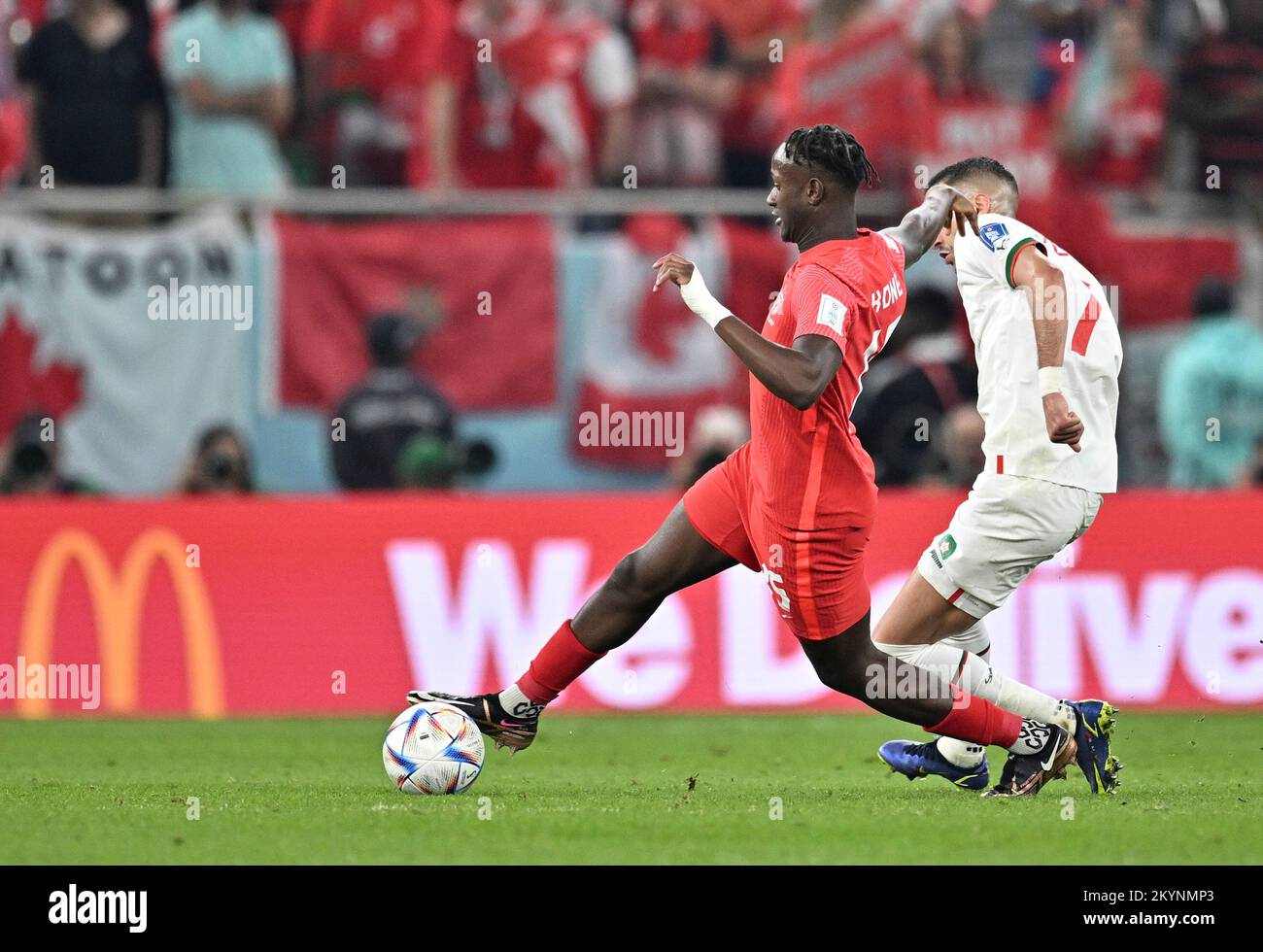 Doha, Qatar. 1st Dec, 2022. Ismael Kone of Canada and Hakim Ziyech of ...