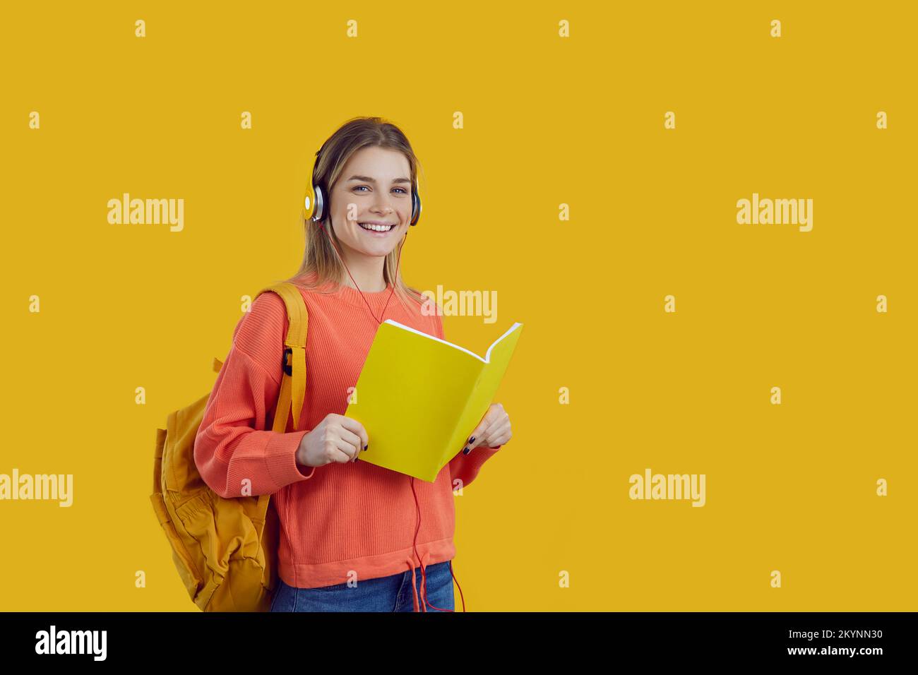 Portrait of beautiful smiling female student girl isolated on yellow ...