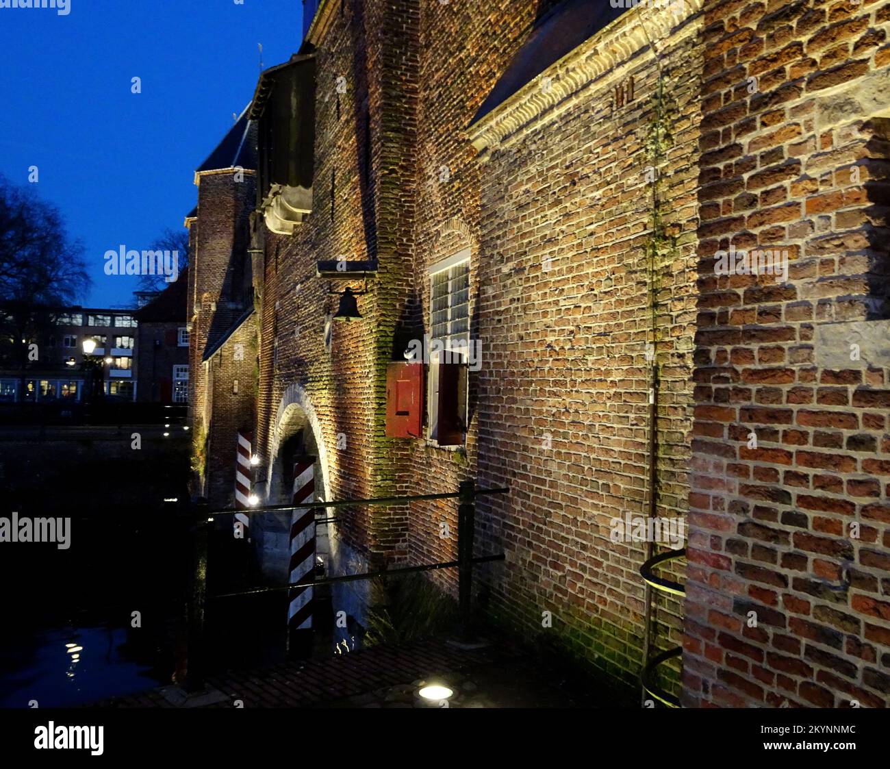 Side view on an illuminated Koppelpoort. This is a medieval gate in the ...